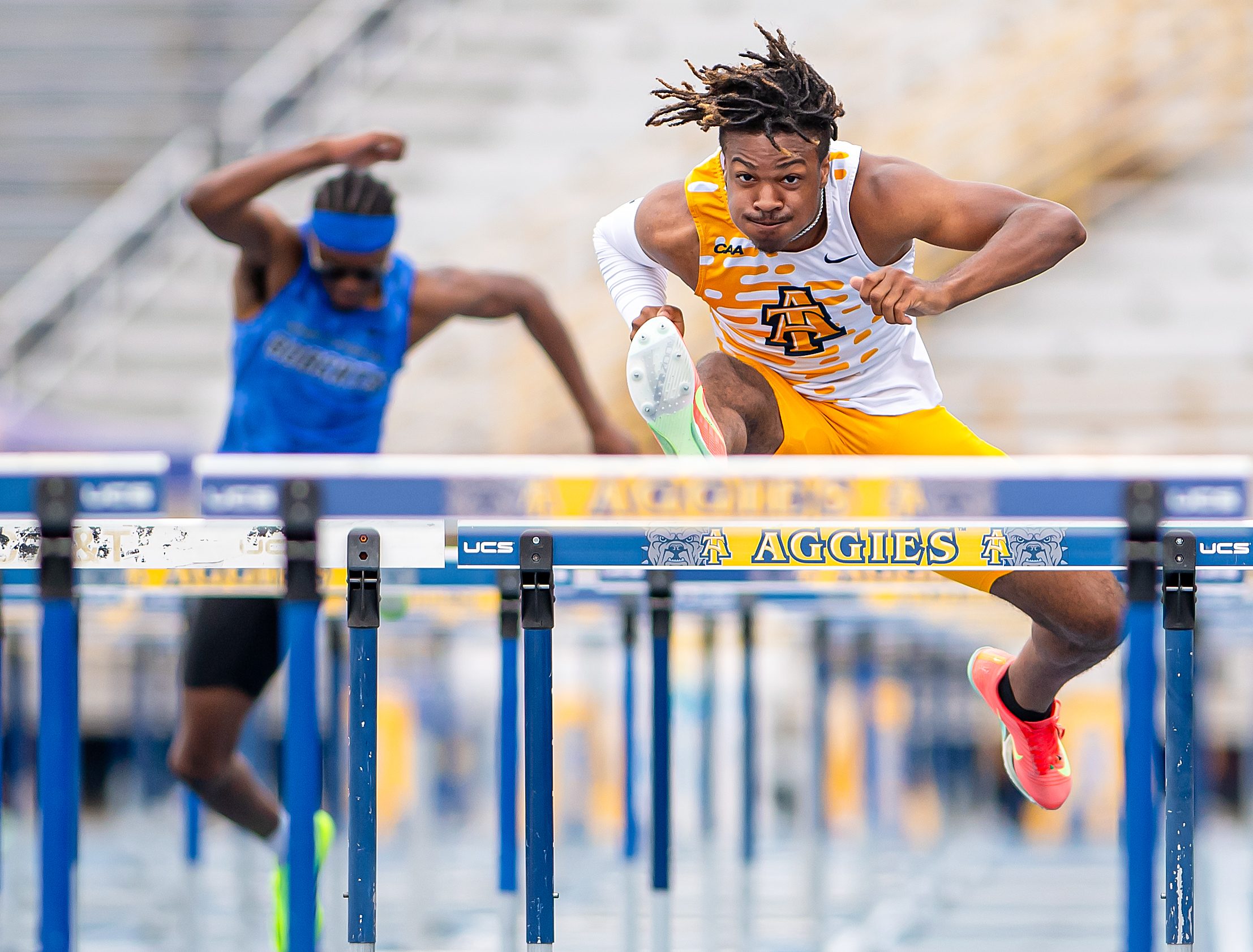 Twin hurdlers from North Carolina A&T chase each other on the track to ...